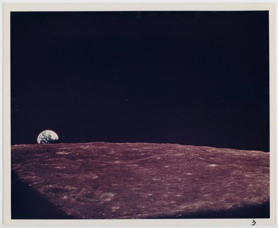 Apollo 8 Earthrise the majestic Earth just emerging above the bleak ...